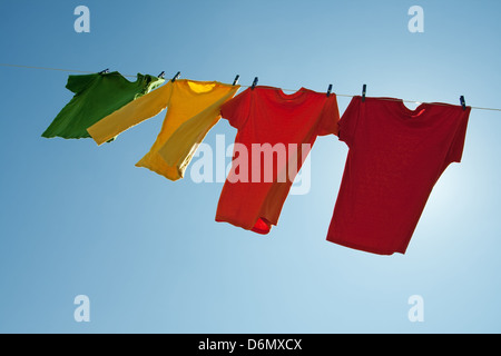 Clothes blowing in the wind. Shirts on a washing line on a windy day ...