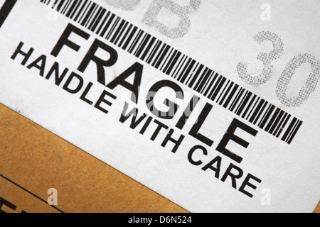 fragile handle with care sticker and barcode on package packaging box ...