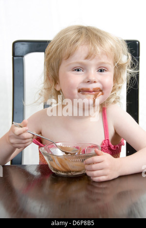 Little Girl Eating Pudding Stock Photo - Alamy