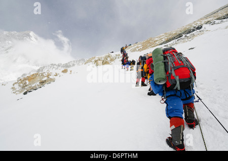 A climber on Mount Everest crossing a crevasse on a ladder in the ...