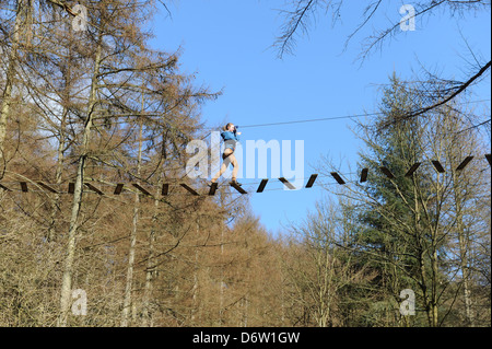 teenager on the GO Ape obstacle course at Dalby forest , england uk ...
