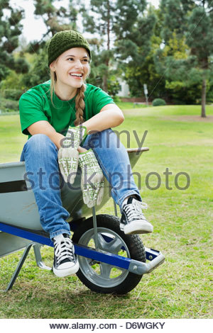 Woman sitting in wheelbarrow in garden Stock Photo: 41443147 - Alamy