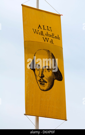 Face of William Shakespeare on a yellow flag against a blue sky as part ...
