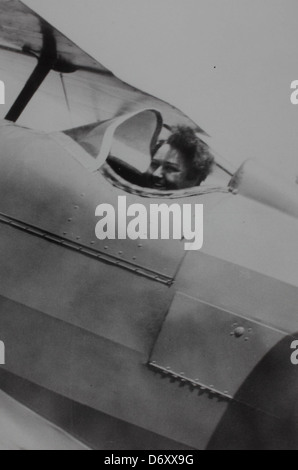 This photo features a woman pilot in the cockpit of an aircraft ...