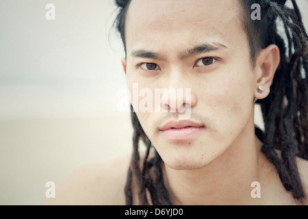 Serious Chinese man with dreadlocks Stock Photo - Alamy