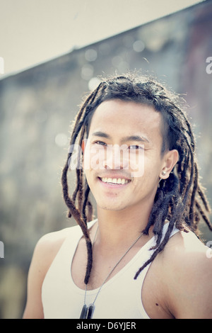 Smiling Chinese man with dreadlocks Stock Photo - Alamy