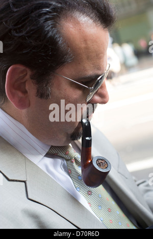 Man smoking a pipe. Foreign journalist reporting on Horse Racing Stock ...