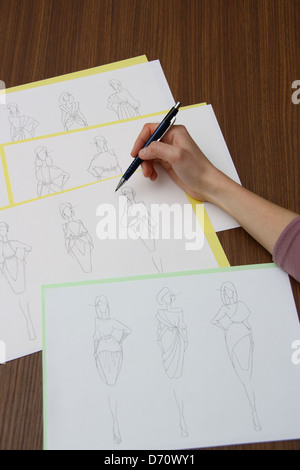 designer assessing fashion drawings on the collection of clothes Stock ...