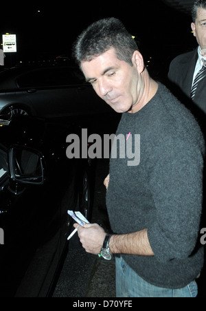 Simon Cowell smoking as he leaves the Dorchester hotel London, England ...