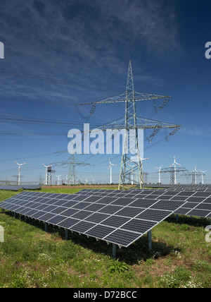 Solar panels with high voltage pylons on blue sky, electricity ...