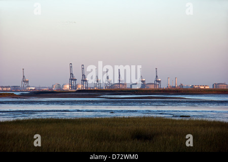 London Thamesport container port with gantry cranes loading a ship ...