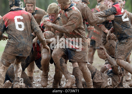Teams battle in the mud during a game at the annual Cherry Blossom ...