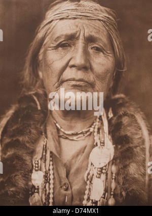 This image features a member of the Hupa tribe fishing from a canoe ...