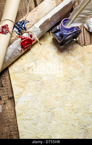 Ancient paper scrolls feather on wooden board copyspace Stock Photo - Alamy