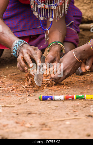Maasai man making fire, Maasai Mara, Kenya Stock Photo - Alamy