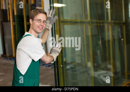 Worker in glazier's workshop, warehouse or storage handling glass Stock ...