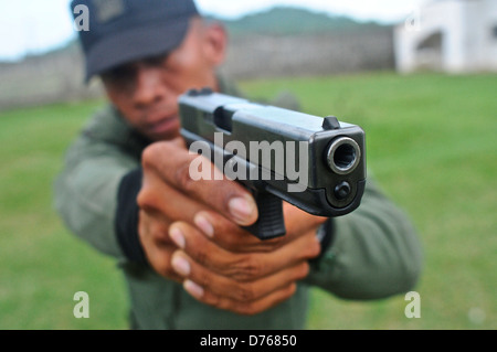 Uniformed police officer aiming pistol tactical firearms training ...