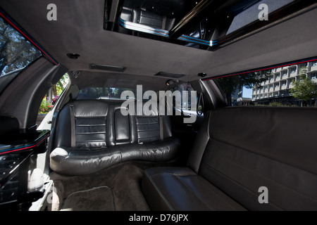Luxury car interior limousine with black leather seats and a small bar ...