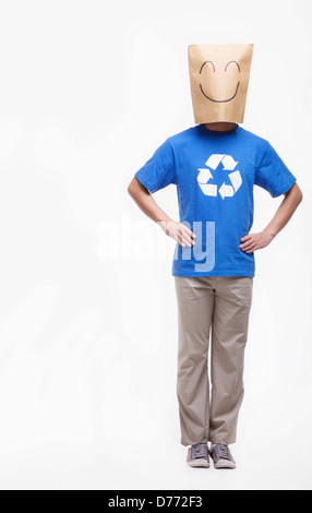 Man with a smiley paper bag on his head. Standing young man is holding ...