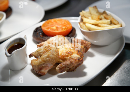 A small roast chicken ( poussin ) with fries, field mushroom, grilled ...