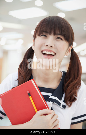 Digital composite of Happy student girl at table using a computer ...