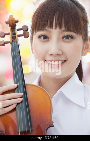 Beautiful young woman holding a violin classical instrument Stock Photo ...