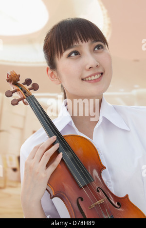Beautiful young woman holding a violin classical instrument Stock Photo ...