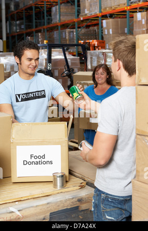 happy volunteers packing food in donation boxes Stock Photo - Alamy