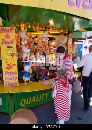 A hook a duck game stall at the funfair at Bardwell in Suffolk, UK ...