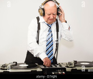 a very funky elderly grandpa dj mixing records Stock Photo - Alamy