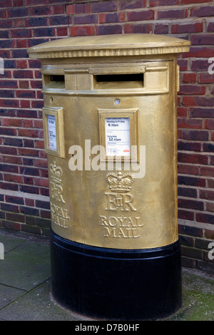 Golden postbox. Royal Mail pillar box painted gold and dedicated to ...