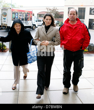 Former Olympic skater Nancy Kerrigan, right, is embraced while arriving ...