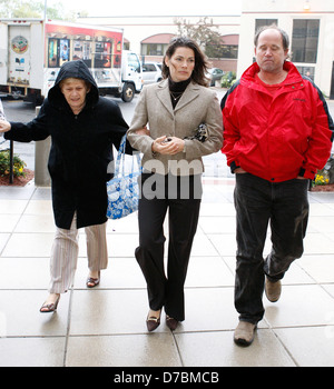Former Olympic skater Nancy Kerrigan, right, is embraced while arriving ...