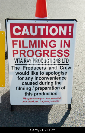 Caution filming in progress sign signage near a film set in Surrey, UK ...