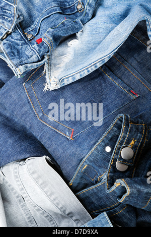 Various pairs of jeans pants scattered in chaos Stock Photo - Alamy