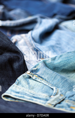 Various pairs of jeans pants scattered in chaos Stock Photo - Alamy