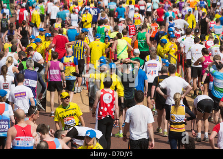 London marathon runners after passing the finish line, wrapped in ...