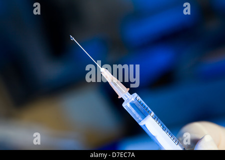Syringe with needle on blur background Stock Photo - Alamy