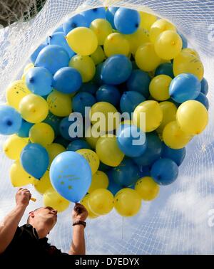 Martin Mogk inflates balloons lettered 'Eurpoe is here' at the Europe ...