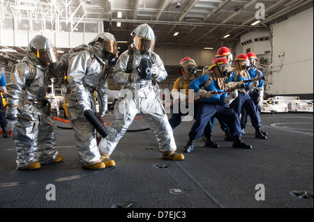 Sailors learn how to man a fire hose. (8559259501 Stock Photo - Alamy