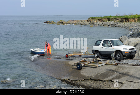 Launching small boat from slipway at River Wyre Estuary Knott End ...