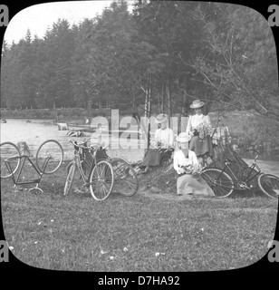 A historical photograph by Herman T. Bohlman showing people walking ...