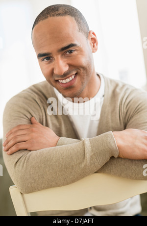 Waist up of calm man in flat hat sitting in barber shop Stock Photo - Alamy