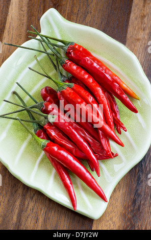 chilli peppers on wooden background Stock Photo - Alamy
