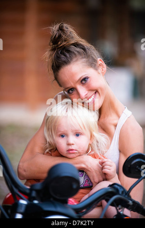 Mother and daughter sitting on motorcycle Stock Photo - Alamy