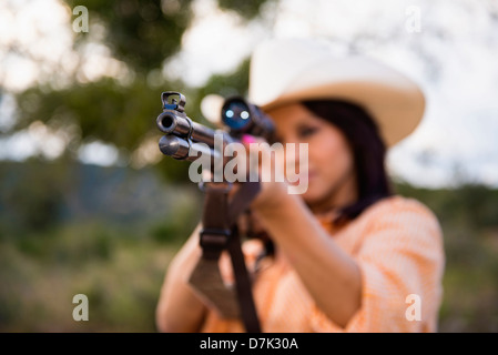 USA, Texas, Young woman aiming hunting rifle Stock Photo: 58078485 - Alamy