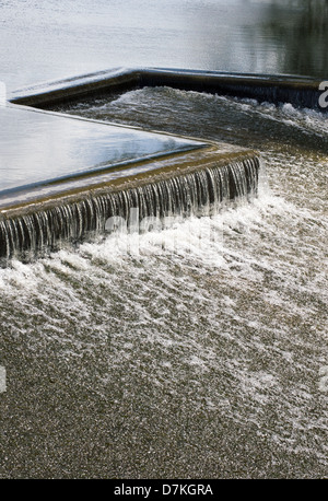 Water pouring in river over outcropping of rock Stock Photo - Alamy