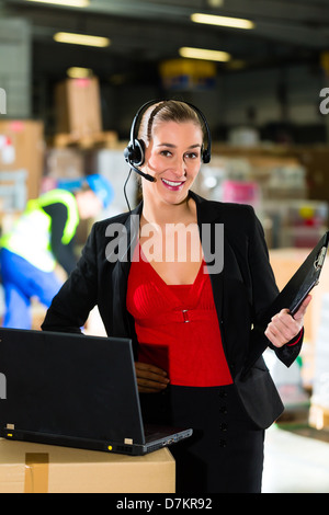 Friendly Woman, dispatcher or supervisor using headset and laptop at ...