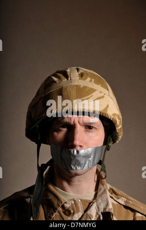 Soldier with his mouth taped over. Soldier is wearing British Military ...