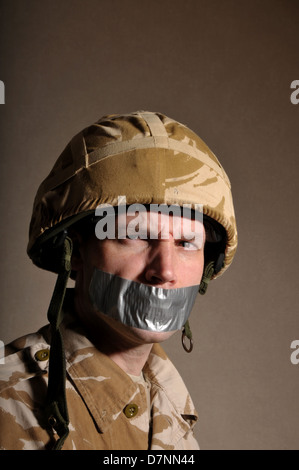 Soldier with his mouth taped over. Soldier is wearing British Military ...